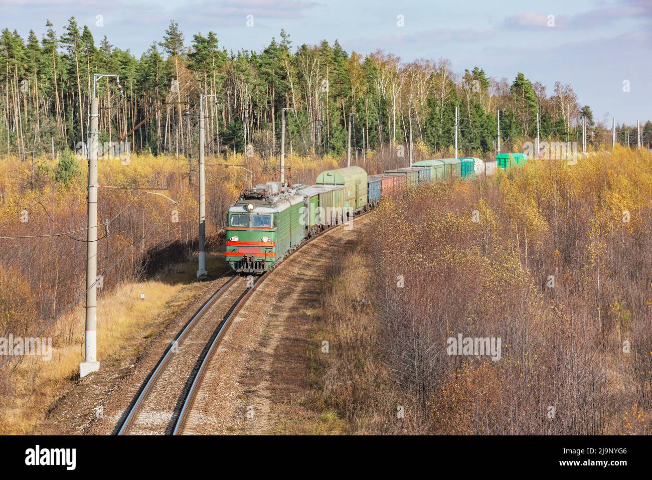 Long freight train approaches to the station at autumn day time Stock ...