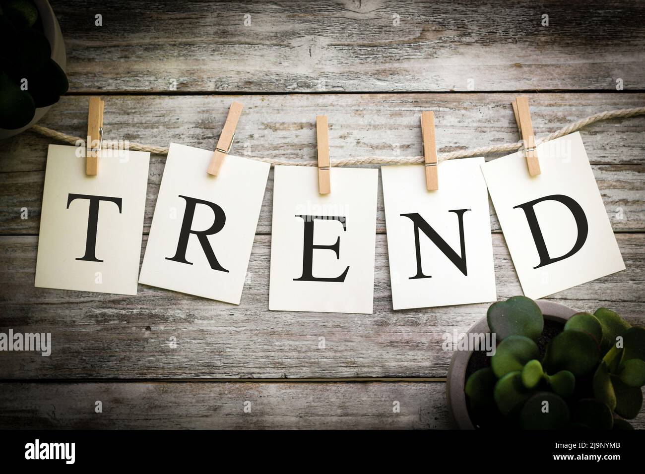 A set of printed cards spelling the word TREND on an aged wooden ...