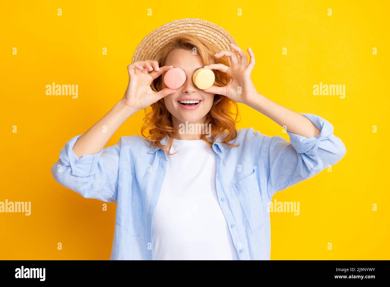 Funny woman hold two cake in front of eyes. Hipster girl. Charming ...