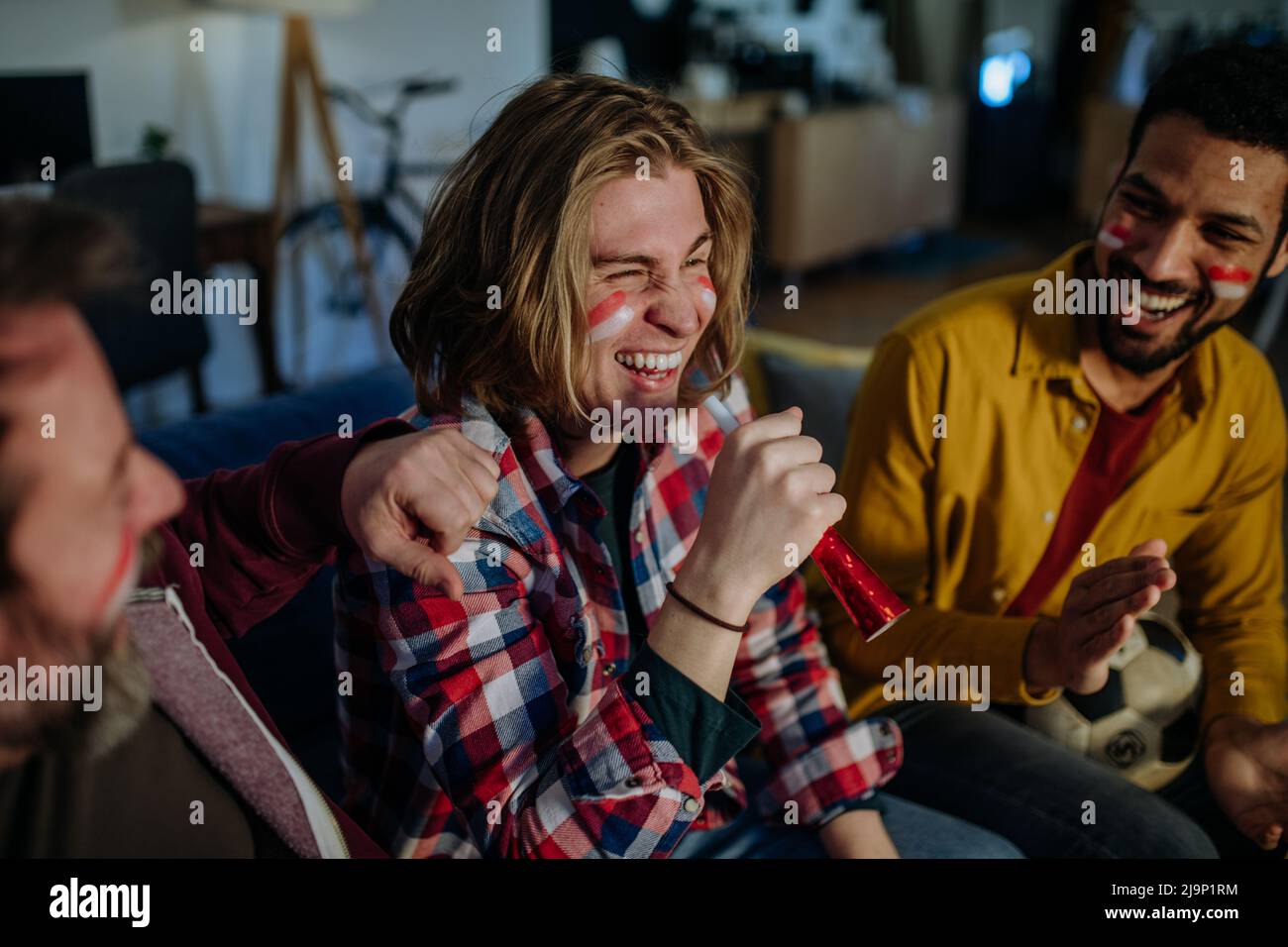 Happy Austrian football fans friends watching football at home and ...
