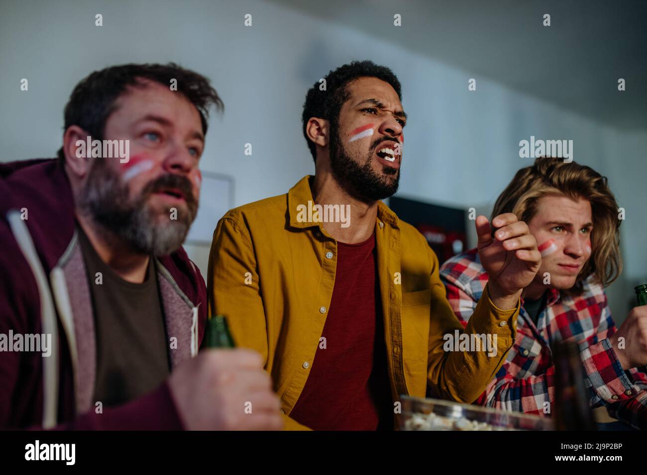 Nervous football fans friends watching a German national team in live ...