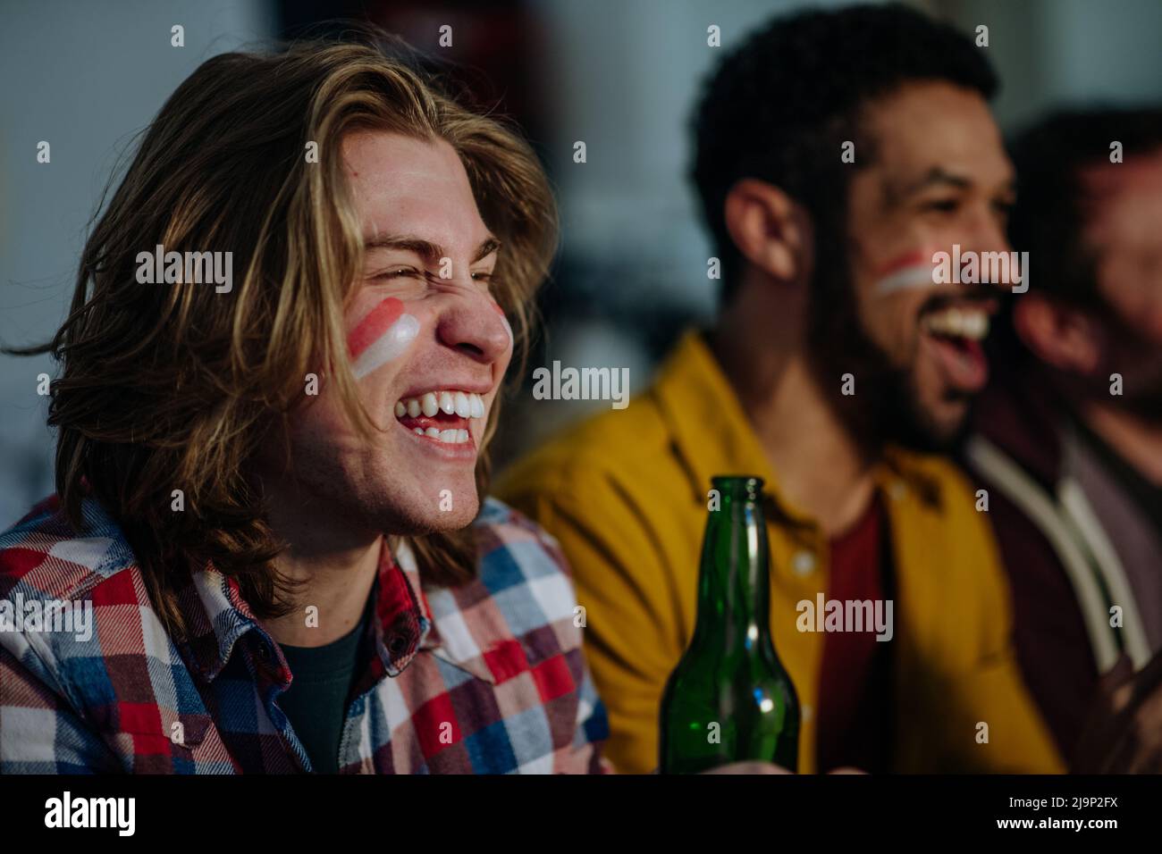 Happy Austrian football fans friends watching football at home and ...