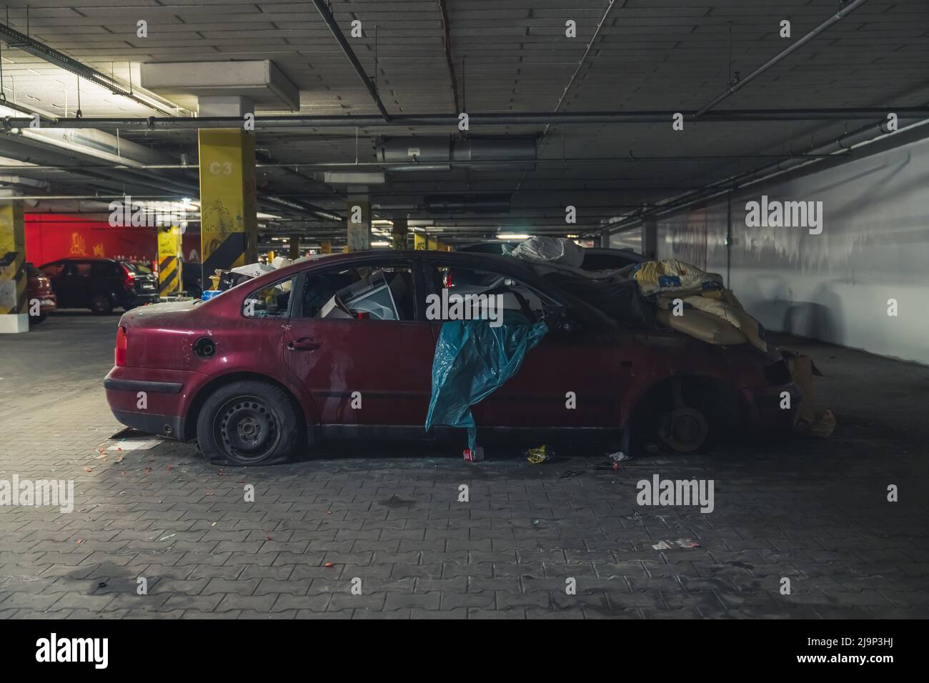 one side of a destroyed car full of dust, filthy with broken screens ...
