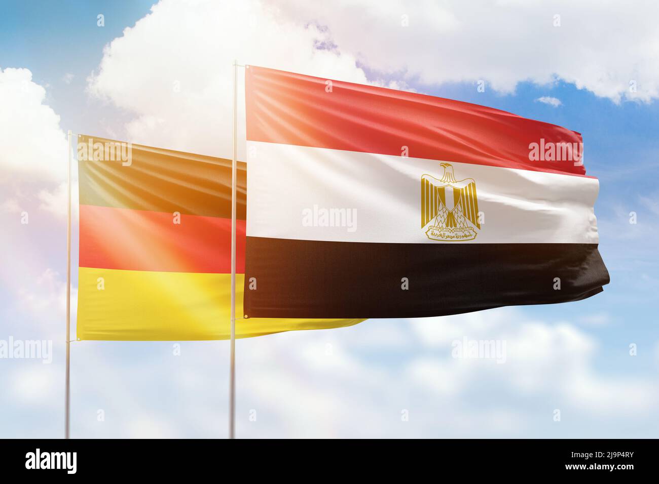 Sunny blue sky and flags of egypt and germany Stock Photo - Alamy