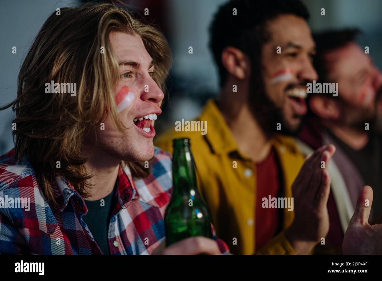 Happy Austrian football fans friends watching football at home and ...
