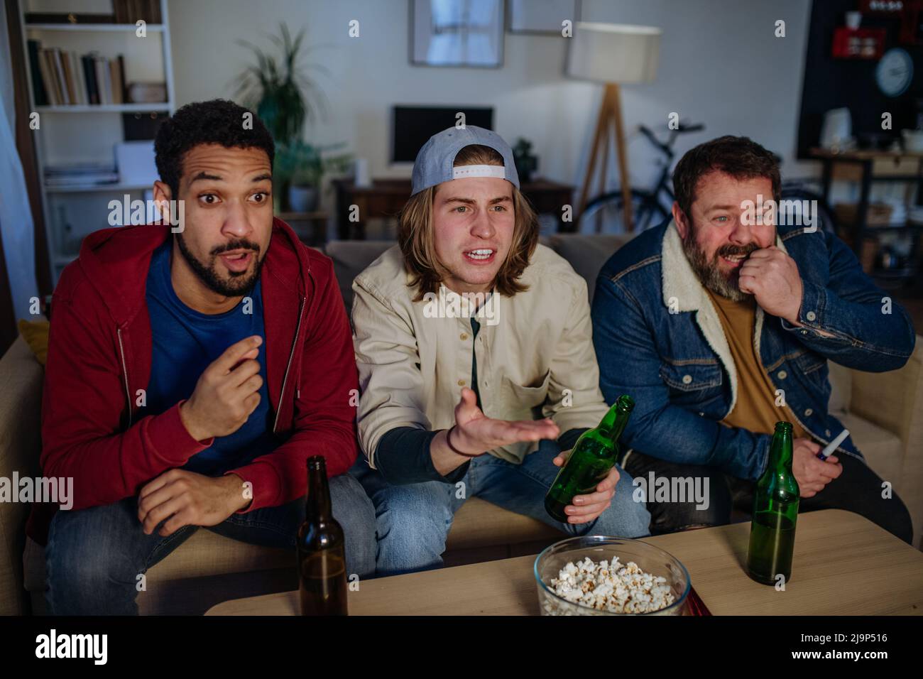 Watching football match on tv cheering hi-res stock photography and ...