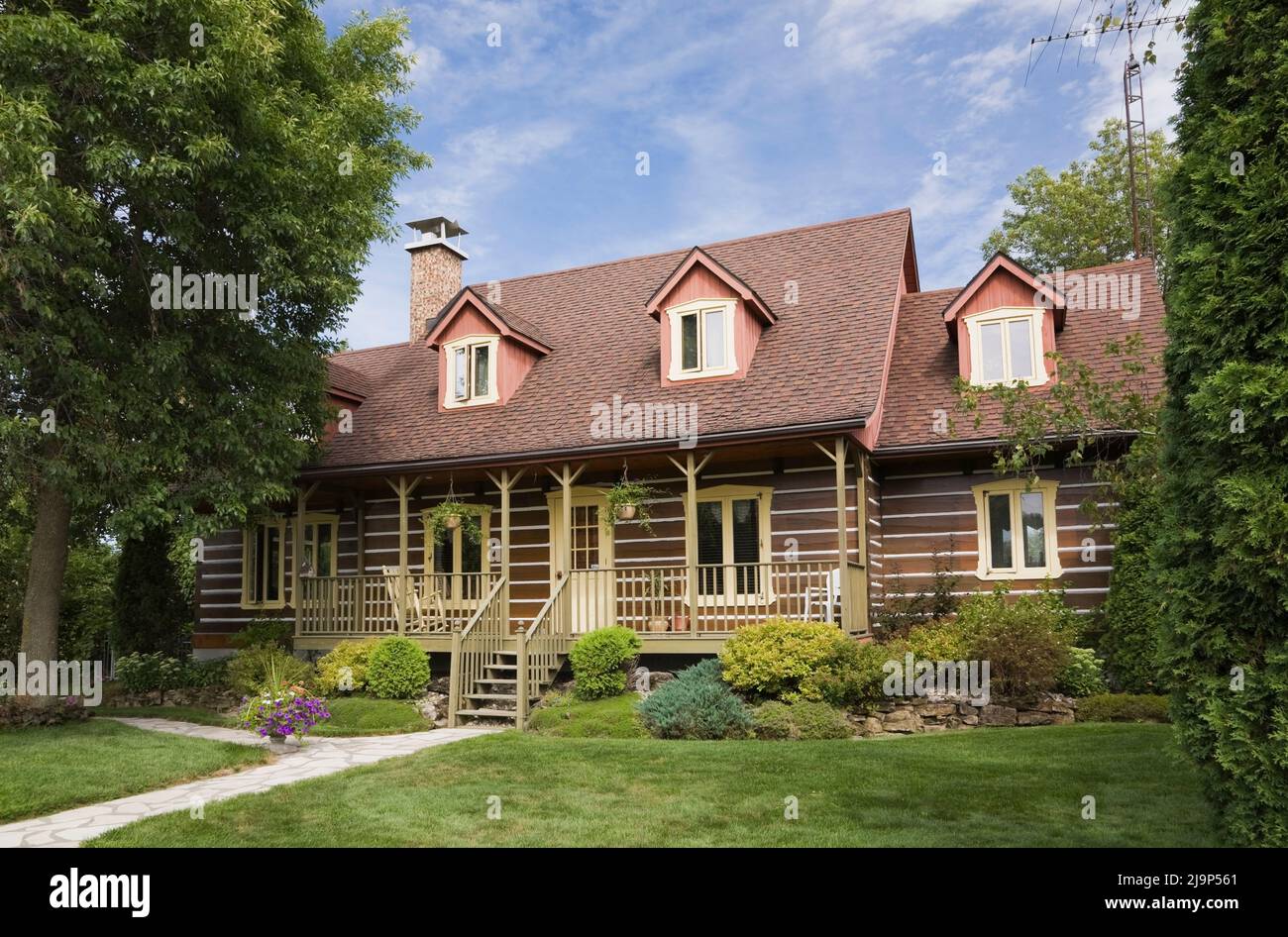 Replica of old 1800s Canadiana cottage style log home with landscaped ...