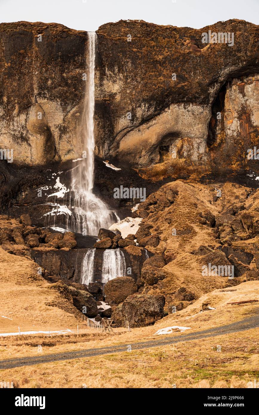 Foss á Síðu, the waterfall off the cliff, in a dry brown late winter ...