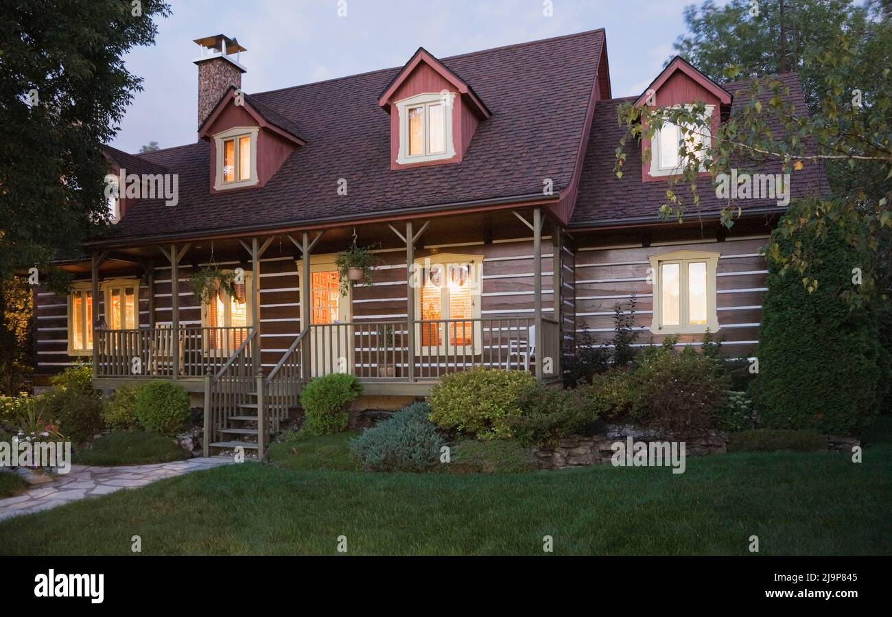 Replica of old 1800s Canadiana cottage style log home with landscaped ...