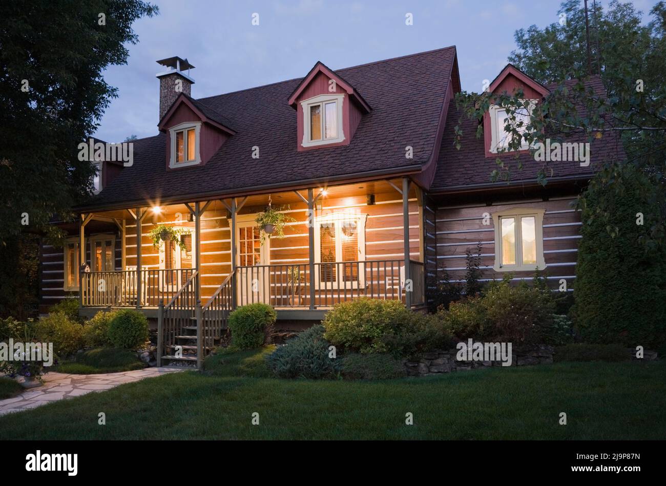 Replica of old 1800s Canadiana cottage style log home with landscaped ...