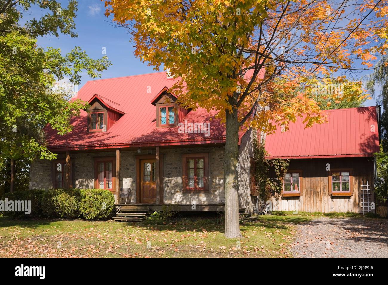 Old circa 1786 Canadiana cottage style fieldstone home facade with red ...