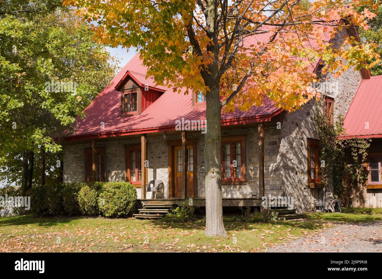 Old circa 1786 Canadiana cottage style fieldstone home facade with red ...