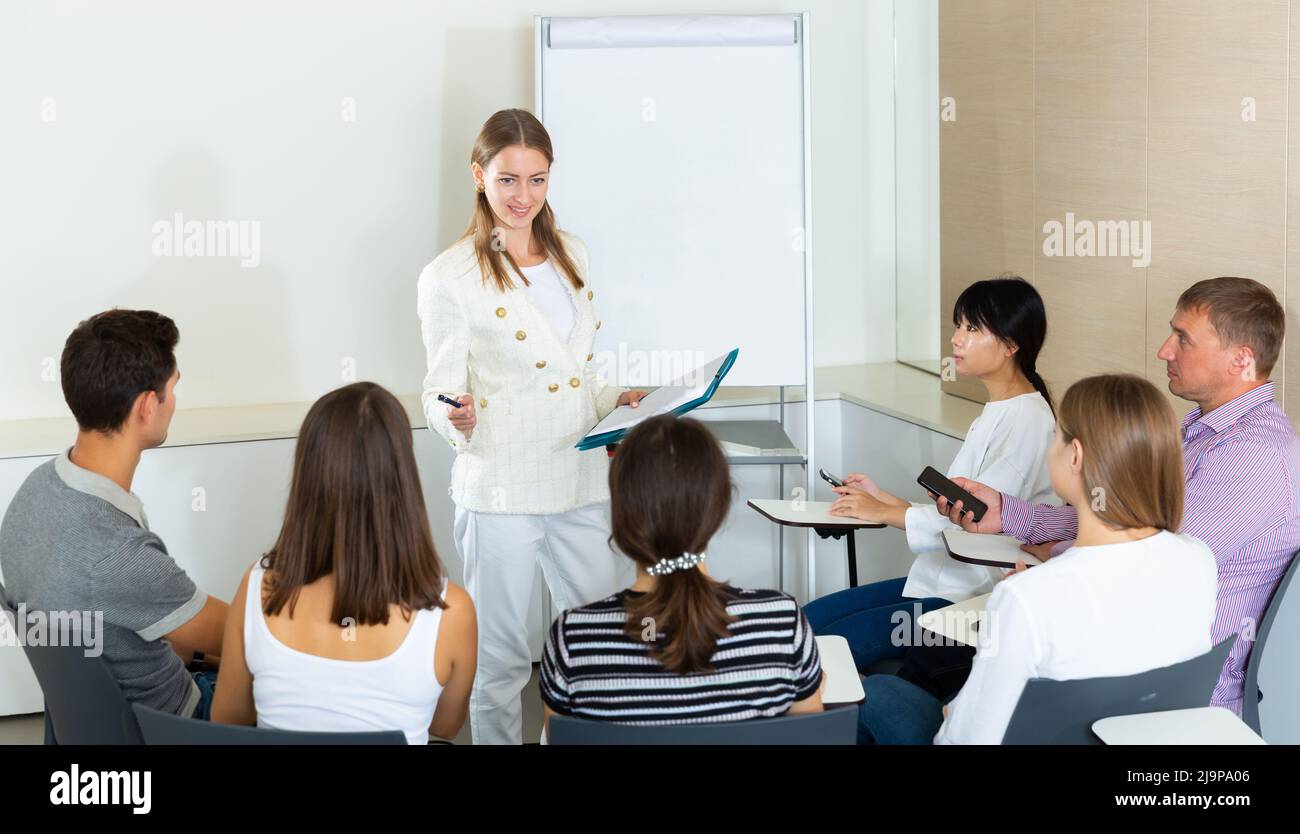 Woman presenting business project to partners Stock Photo - Alamy