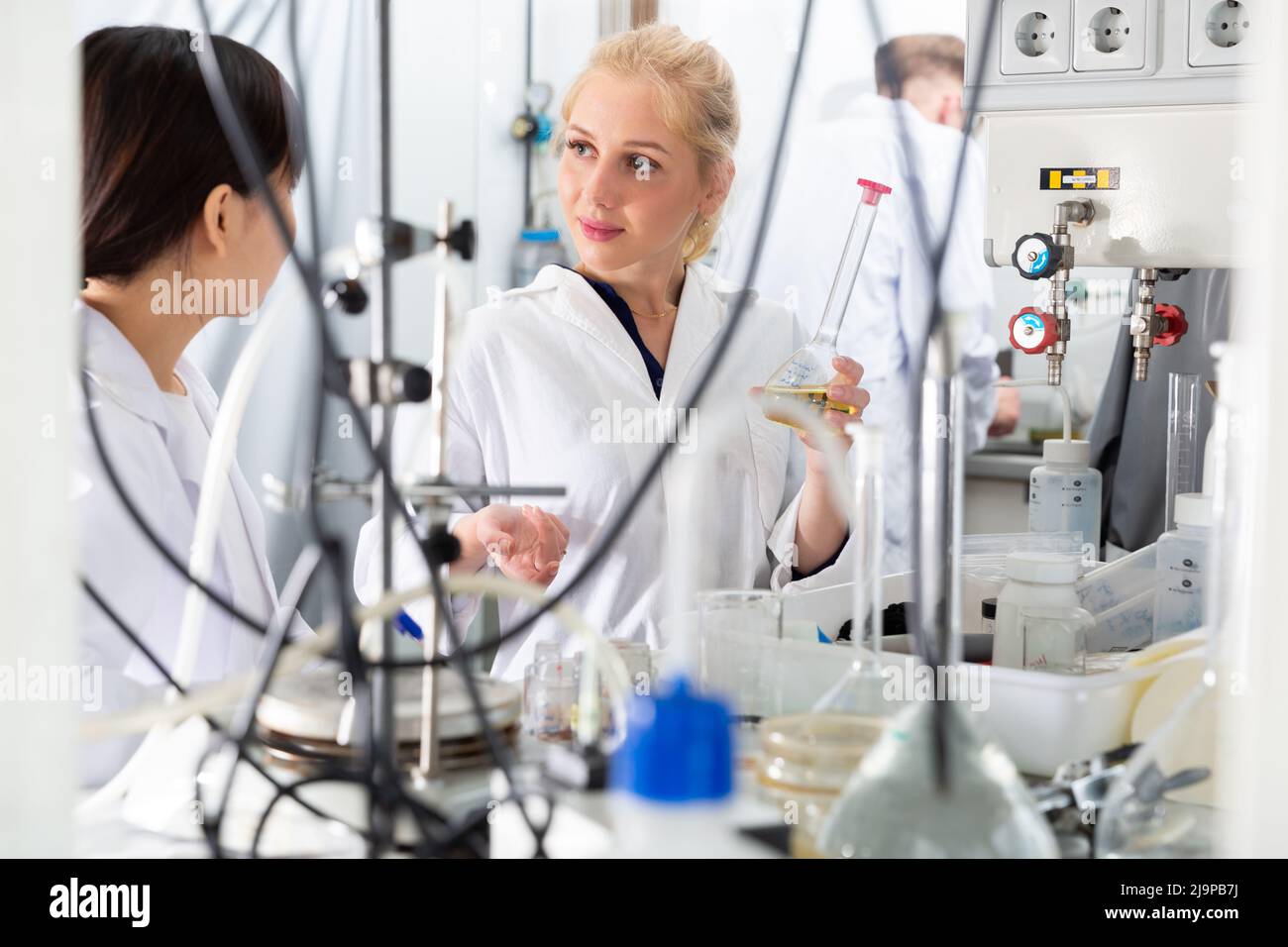Woman lab technician with female assistant working with reagents Stock ...