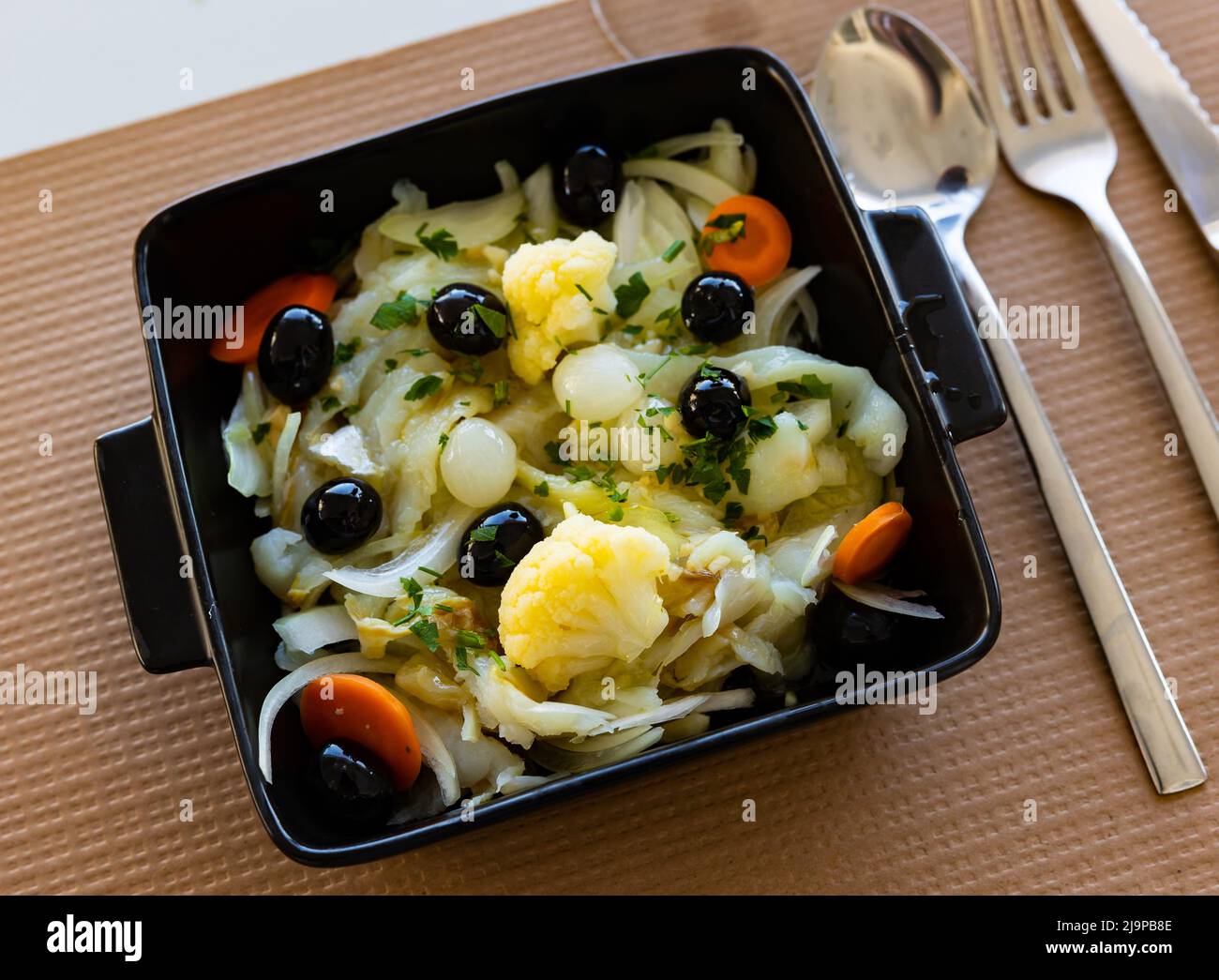 Salad of codfish with marinated onions, cauliflower, carrots and olives ...