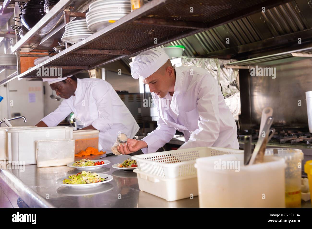 Professional responsible chef working in restaurant kitchen Stock Photo ...