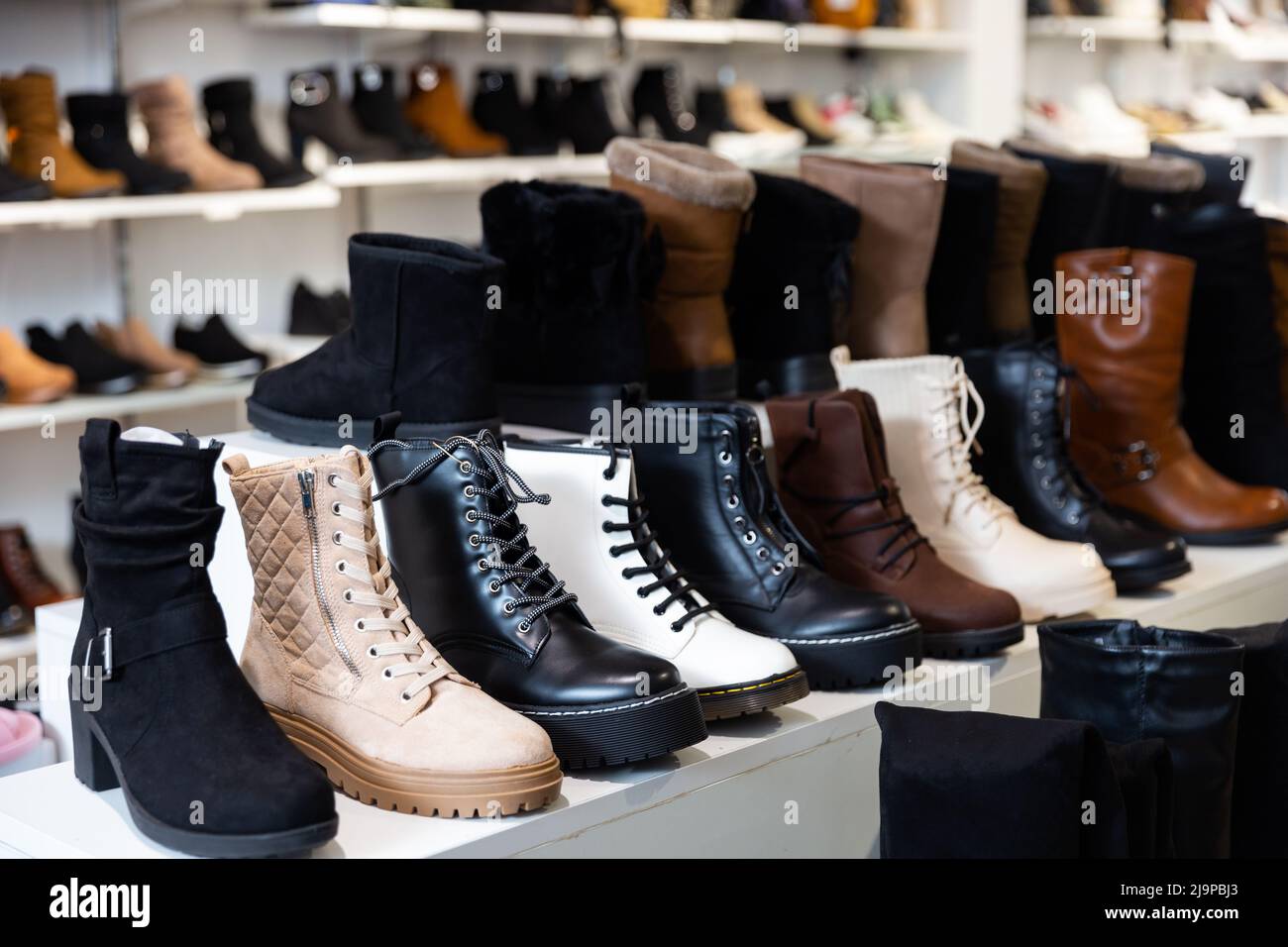 Womens demi-season ankle boots on stand in shoe store Stock Photo - Alamy