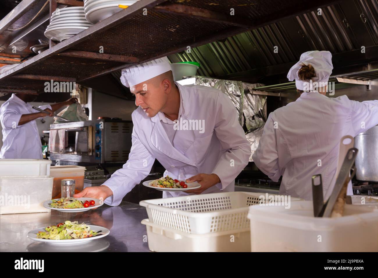 Professional responsible chef working in restaurant kitchen Stock Photo ...