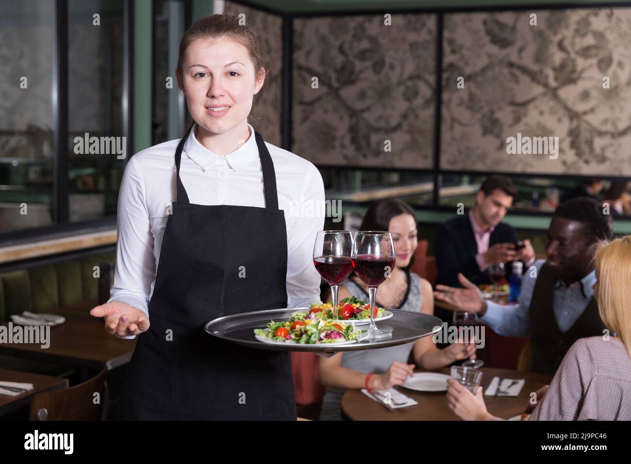 Smiling waitress with serving tray Stock Photo - Alamy