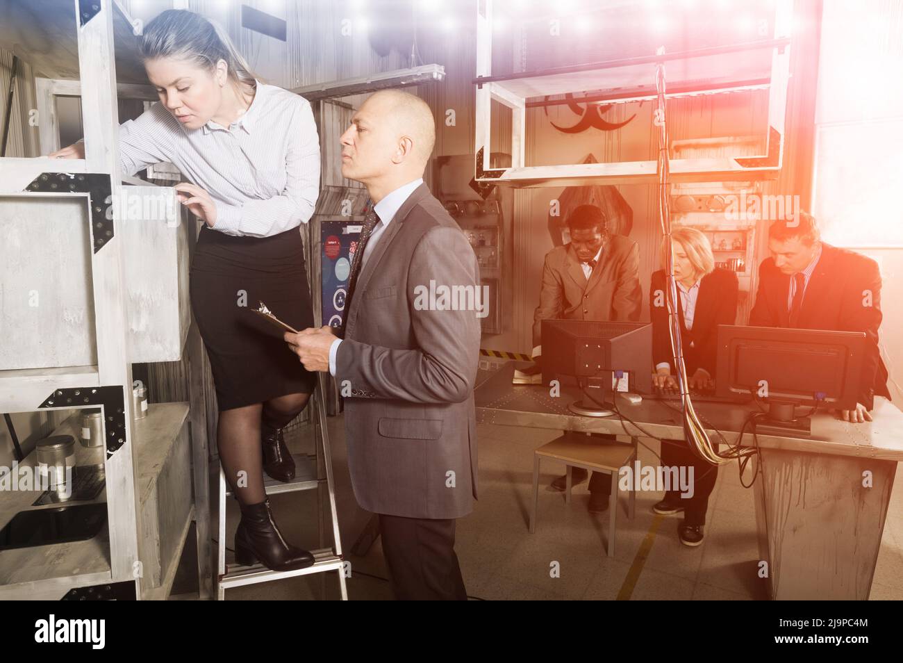 Toned image of businesspeople in escape room-laboratory Stock Photo - Alamy
