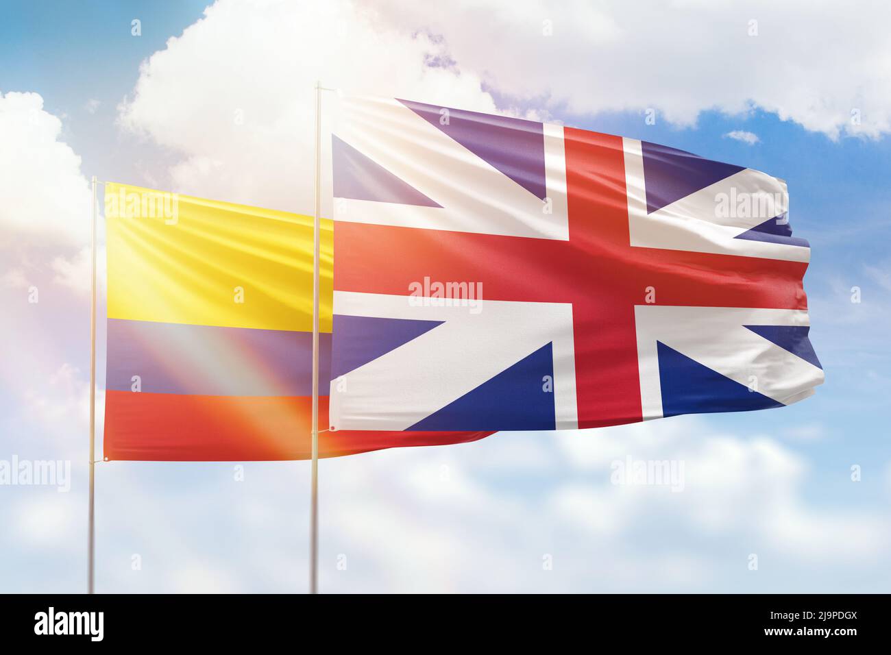 Sunny blue sky and flags of great britain and colombia Stock Photo - Alamy