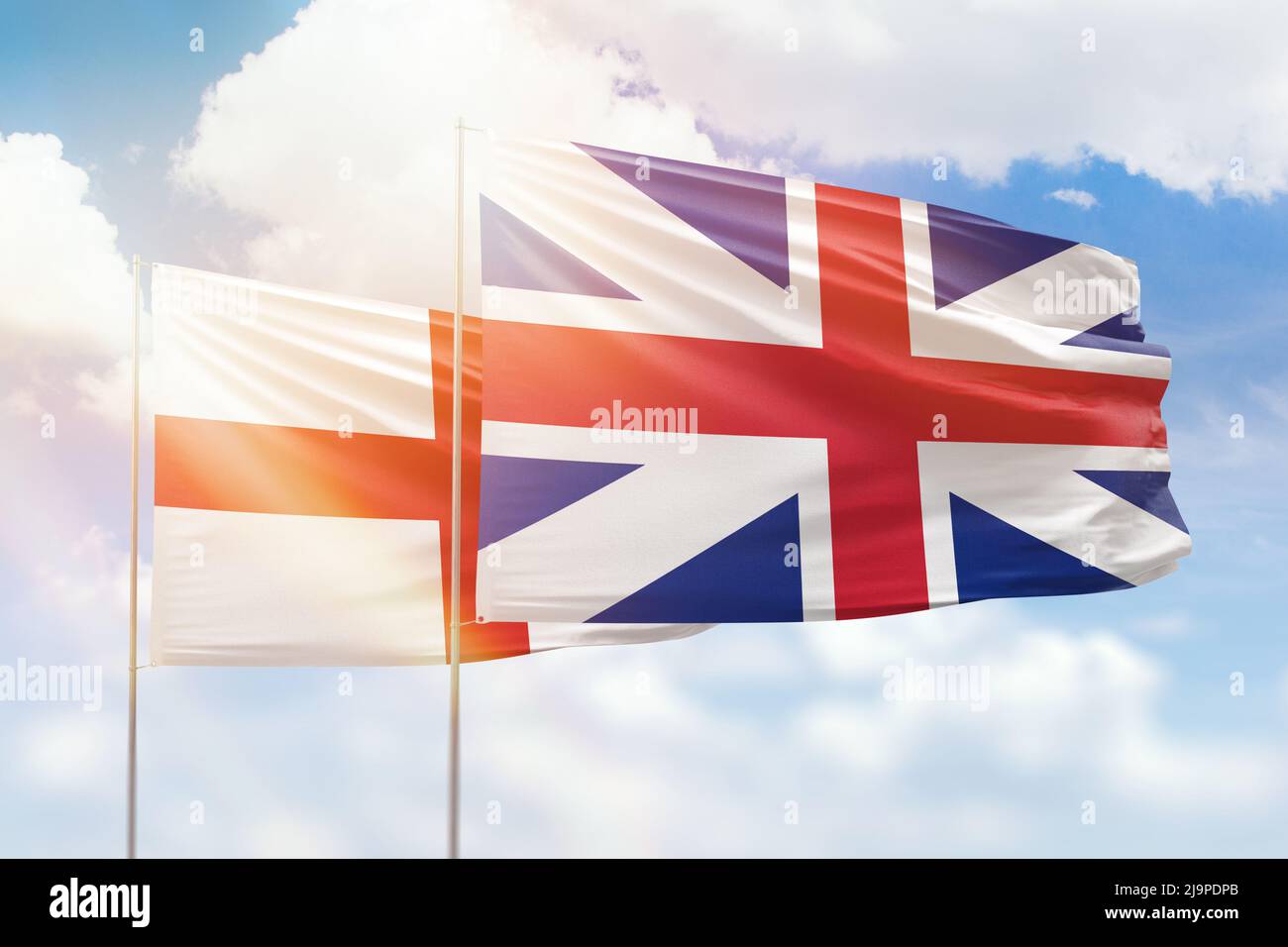 Sunny blue sky and flags of great britain and england Stock Photo - Alamy