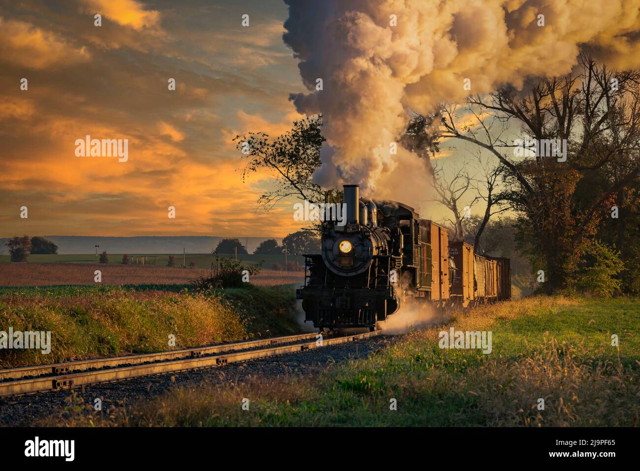 A View of an Antique Freight Steam Train Blowing Smoke Approaching Thru ...