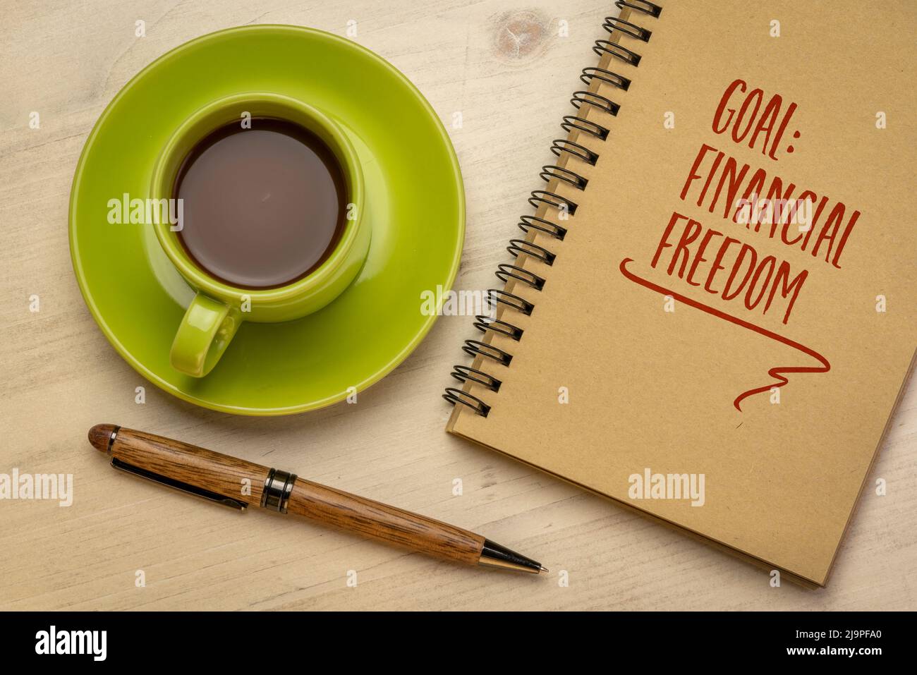 financial freedom - goal setting concept, handwriting in a notebook ...