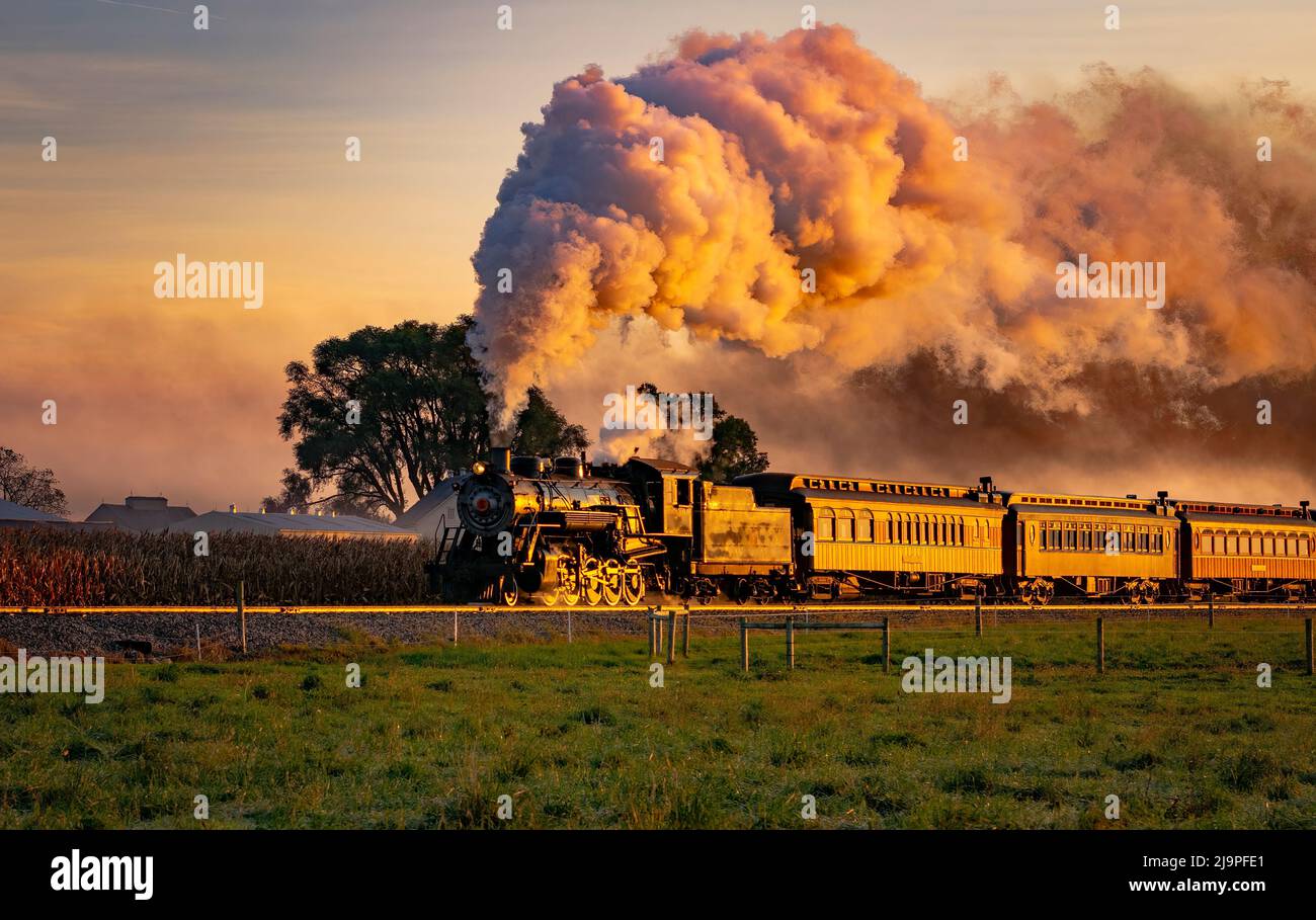 A View of an Antique Steam Passenger Train Approaching at Sunrise With ...