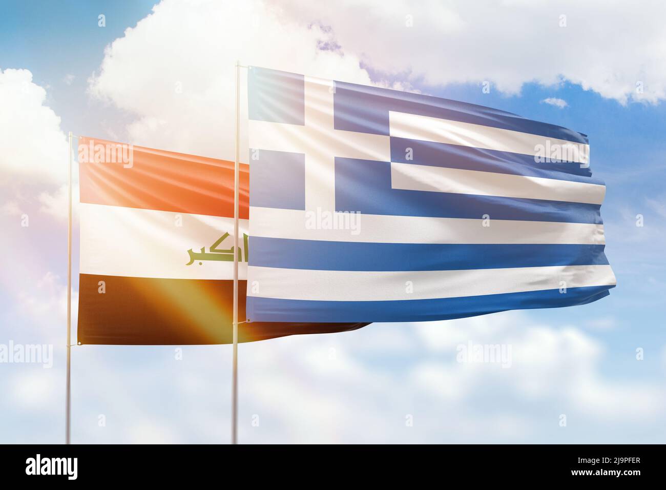 Sunny blue sky and flags of greece and iraq Stock Photo - Alamy