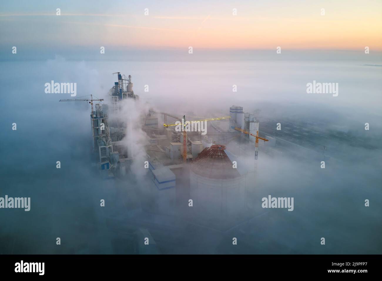 Aerial view of cement factory with high concrete plant structure and ...