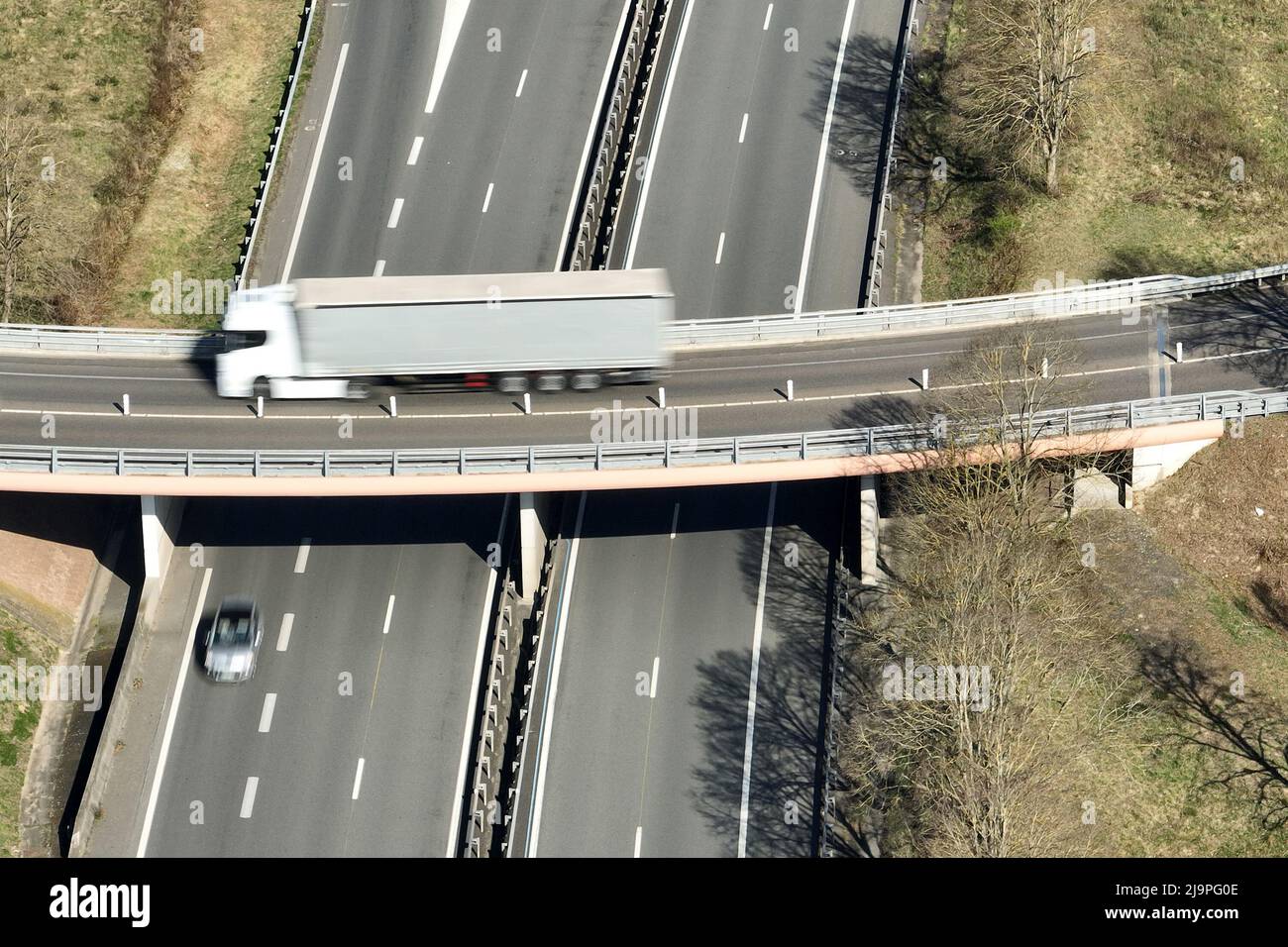 Aerial view of highway road intersection with fast moving heavy traffic ...