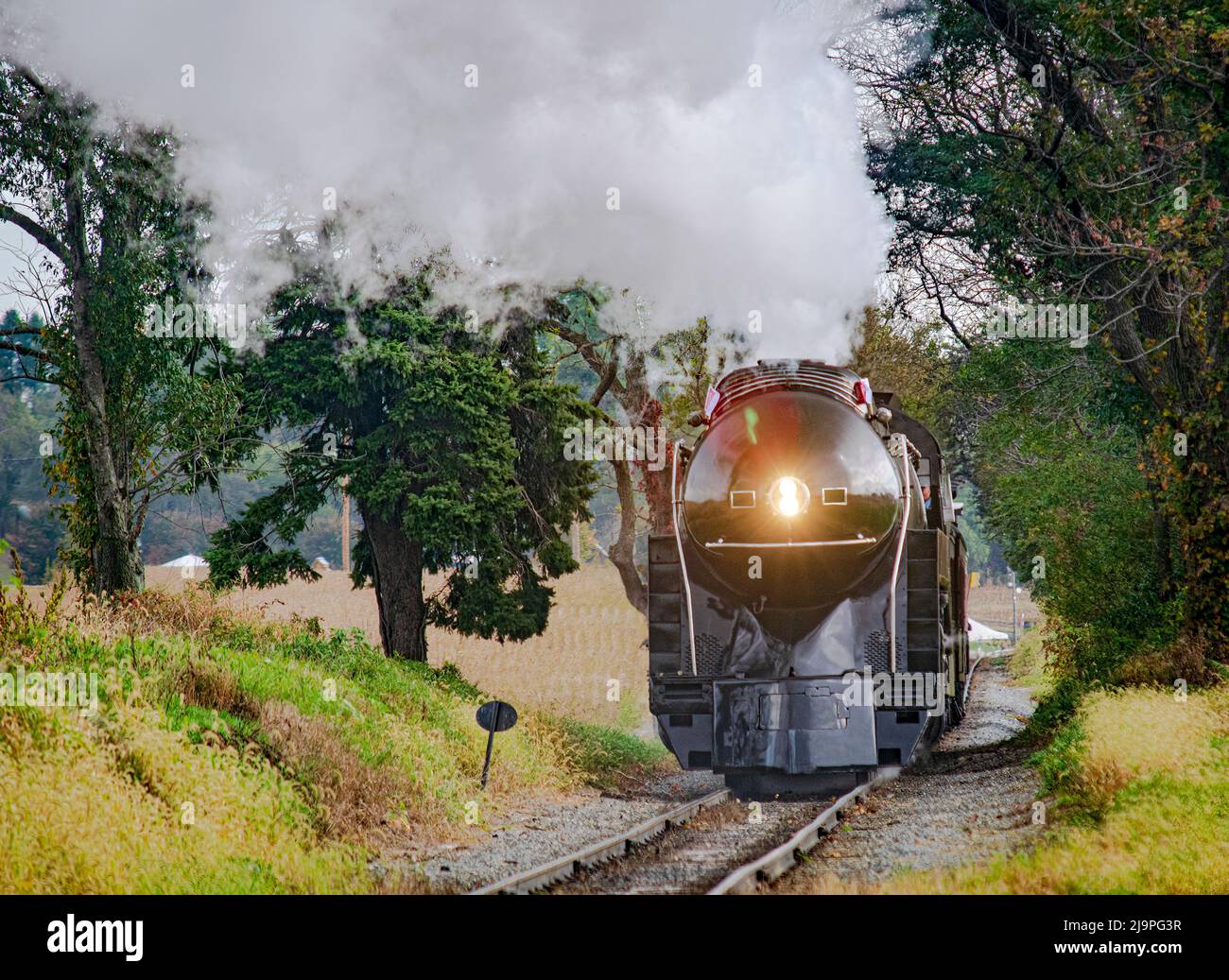 An Antique Restored Steam Engine Approaching Head-on, On Some Old Rail ...