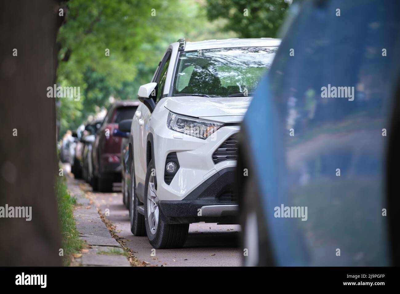 Cars parked in line on city street side. Urban traffic concept Stock ...
