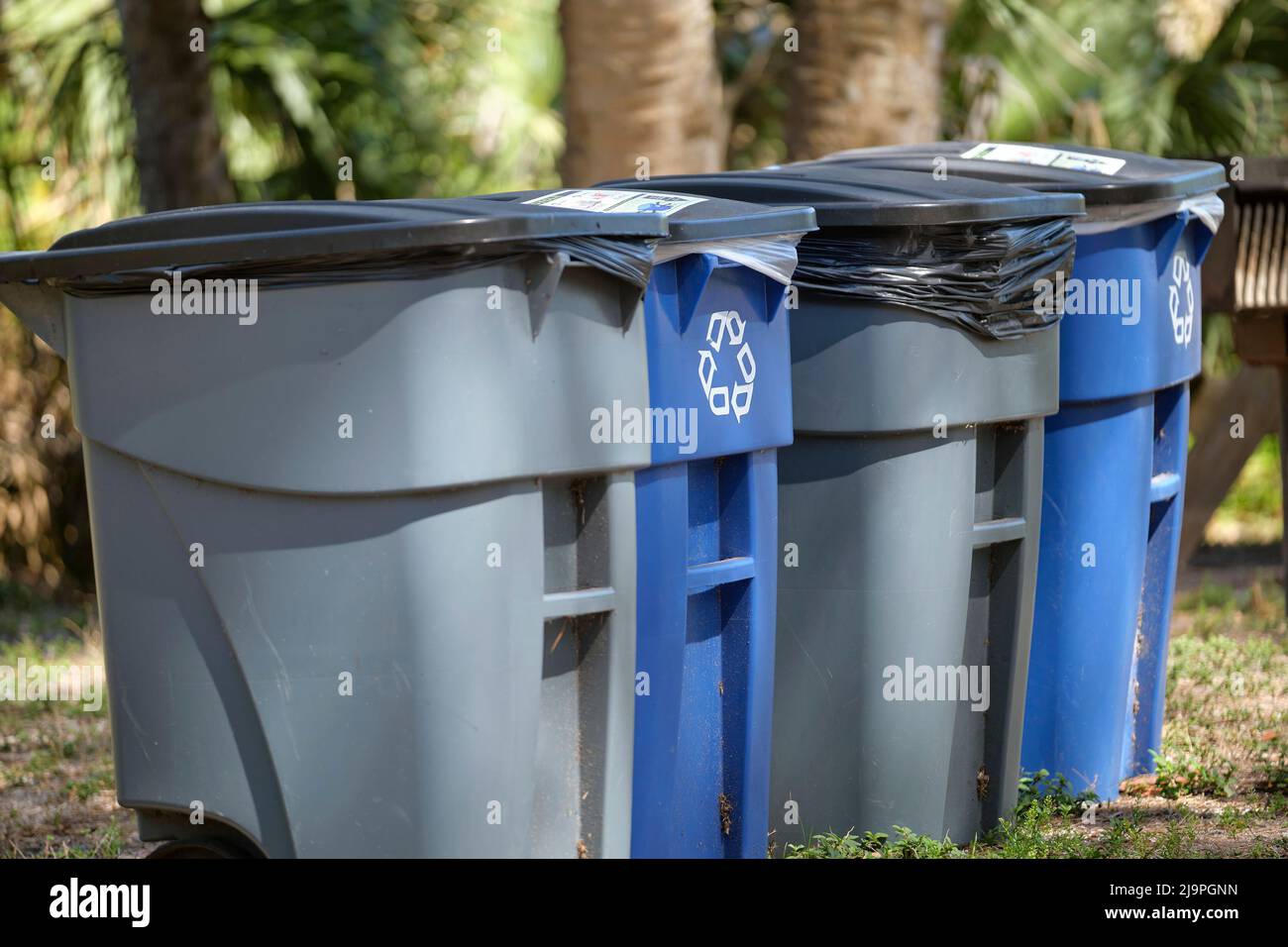 Garbage cans for separate disposal of recycle trash on city street ...