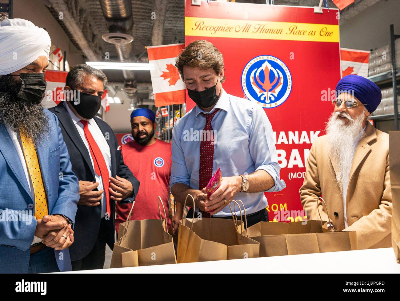 Surrey, Canada. 24th May, 2022. Prime Minister Justin Trudeau helps put ...