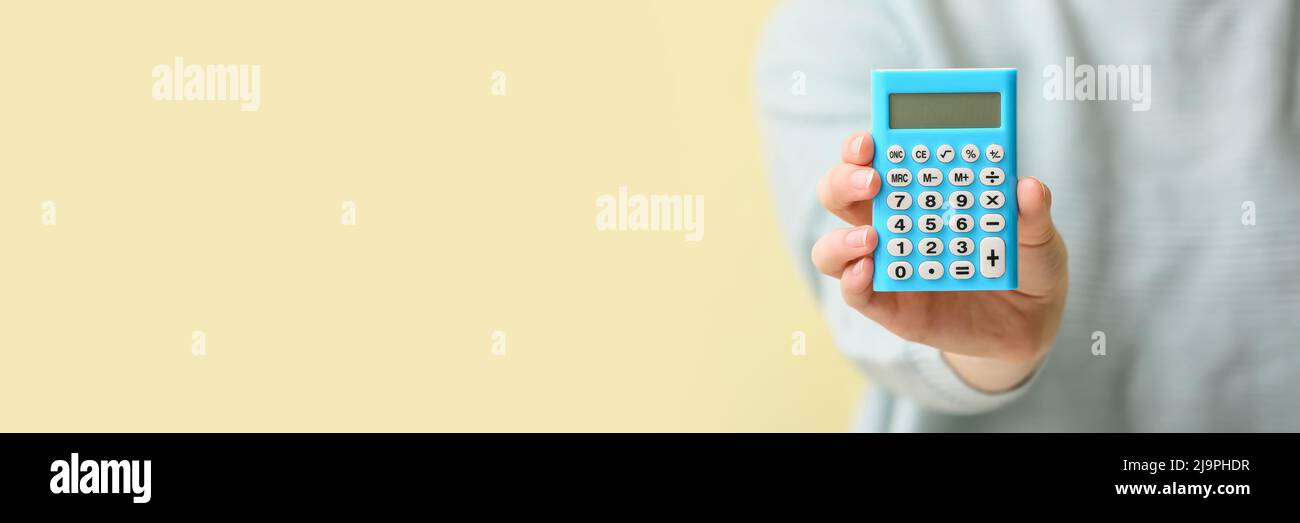 Woman holding calculator on hi-res stock photography and images - Alamy