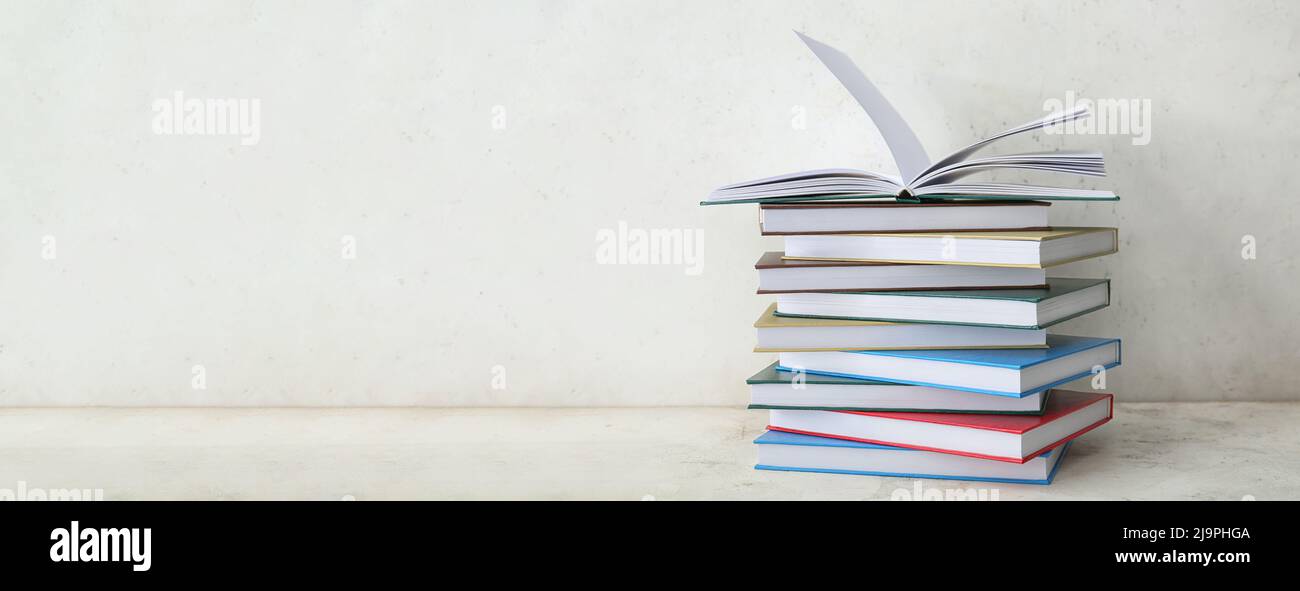 Stacks of books on light table. Banner for design Stock Photo - Alamy