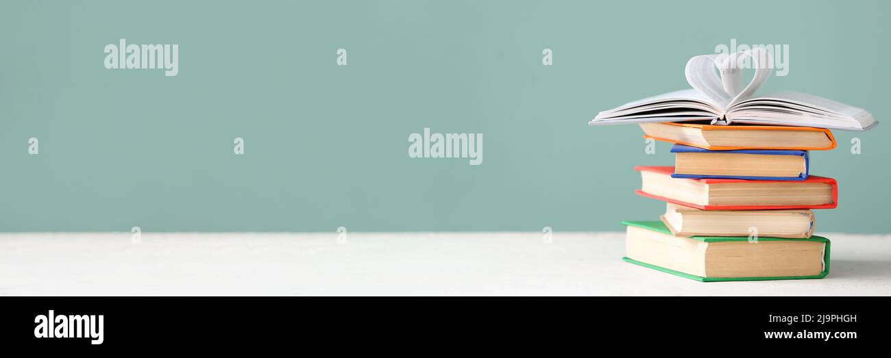 Many books on table against color background. Banner for design Stock ...