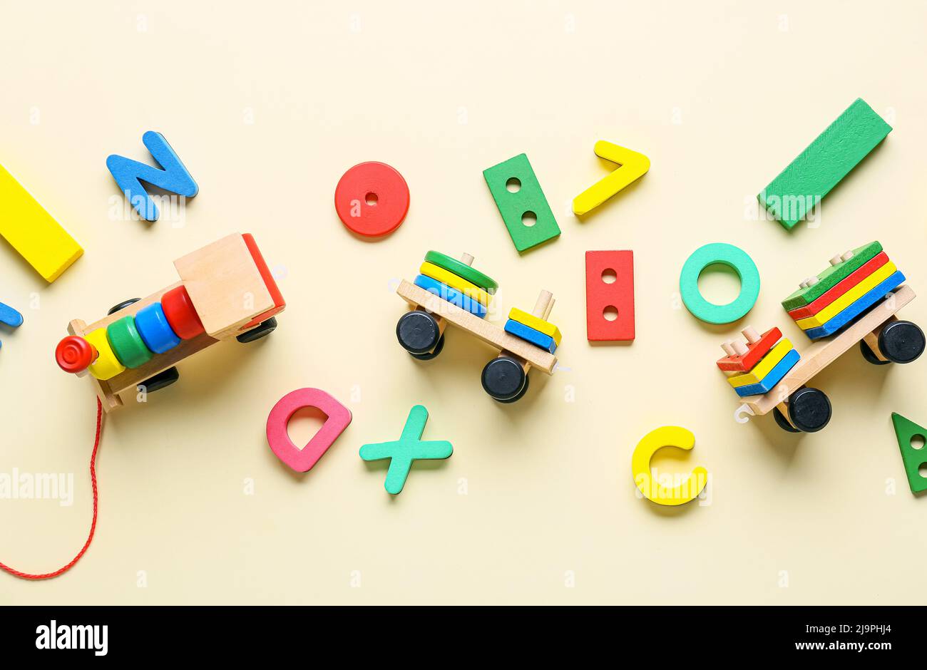 Toy train with building blocks and letters on beige background Stock ...