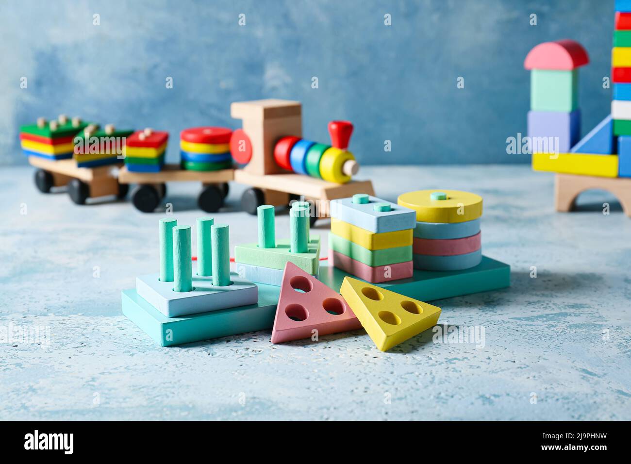 Children building blocks on blue background Stock Photo - Alamy