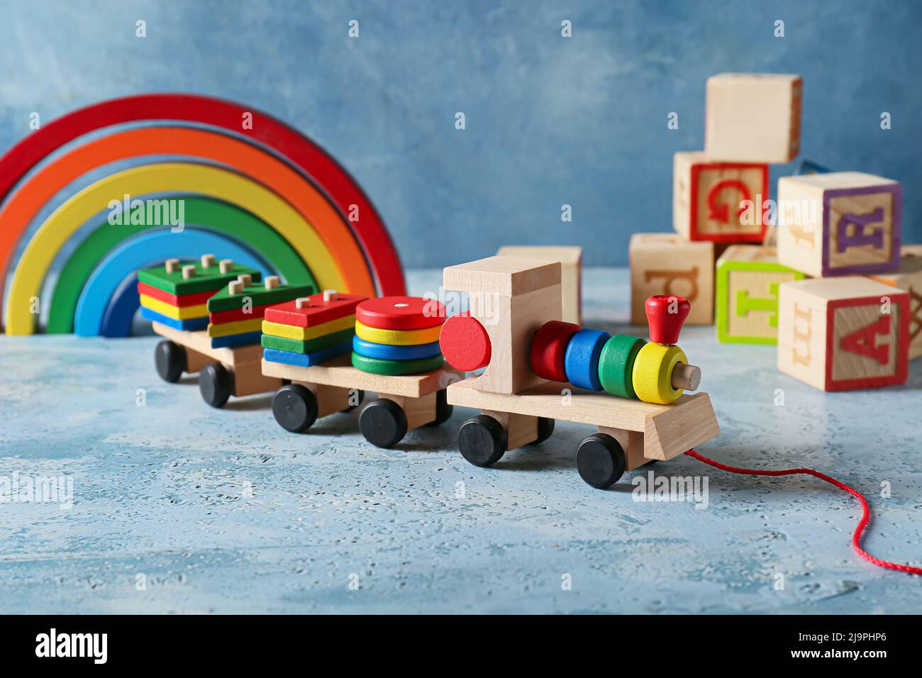 Toy train with building blocks on blue background Stock Photo - Alamy