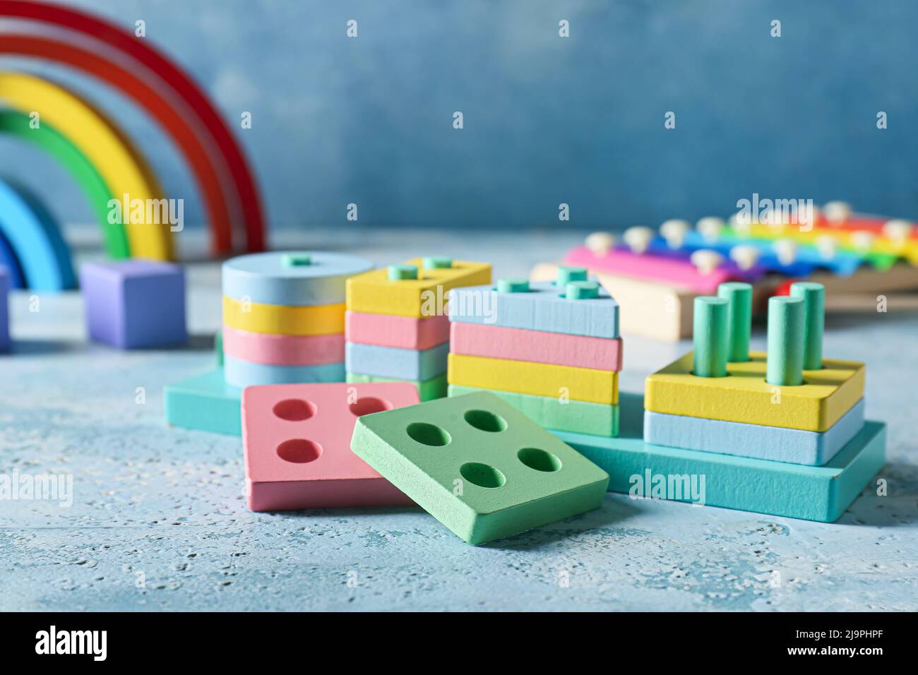 Children building blocks on blue background Stock Photo - Alamy