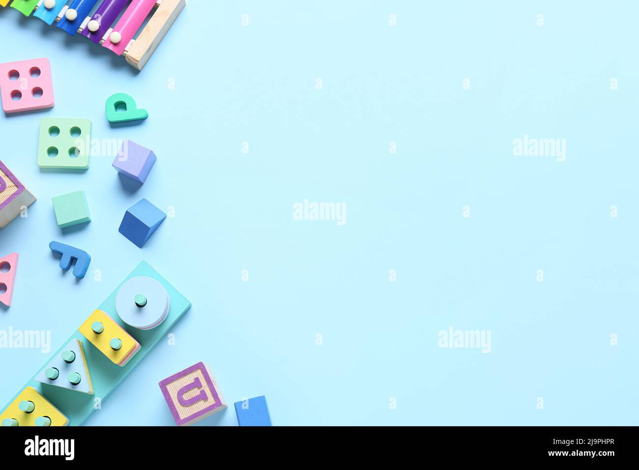 Children building blocks on blue background Stock Photo - Alamy