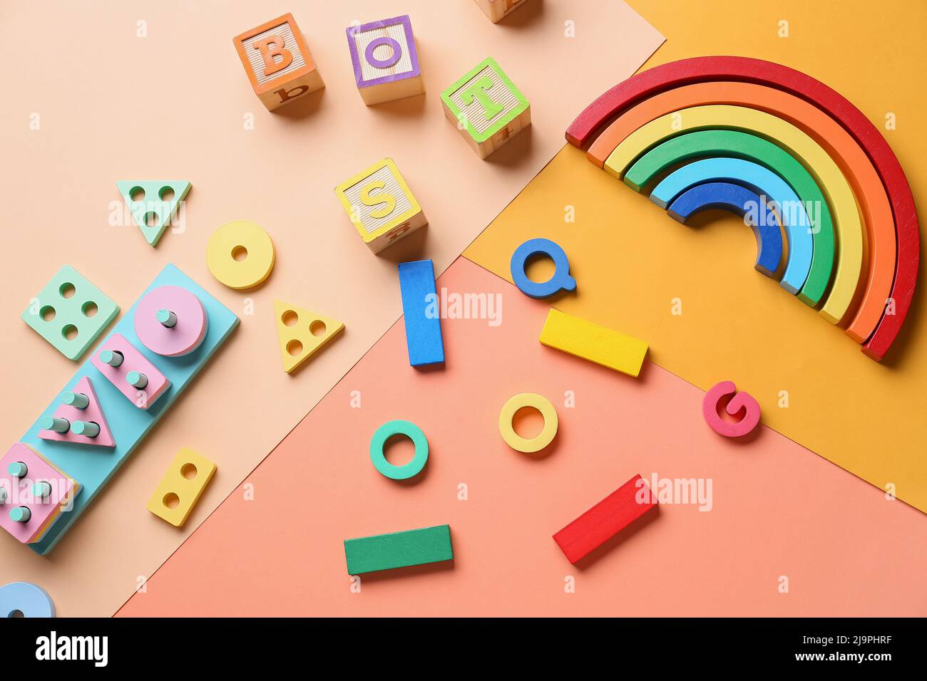 Children building blocks on color background Stock Photo - Alamy
