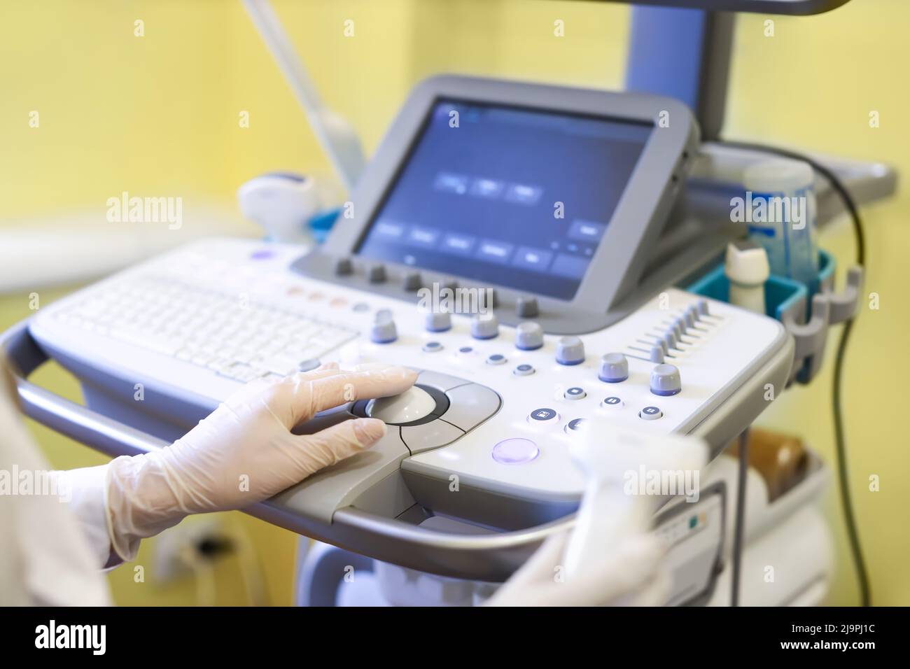 Doctor using ultrasound machine in clinic Stock Photo - Alamy