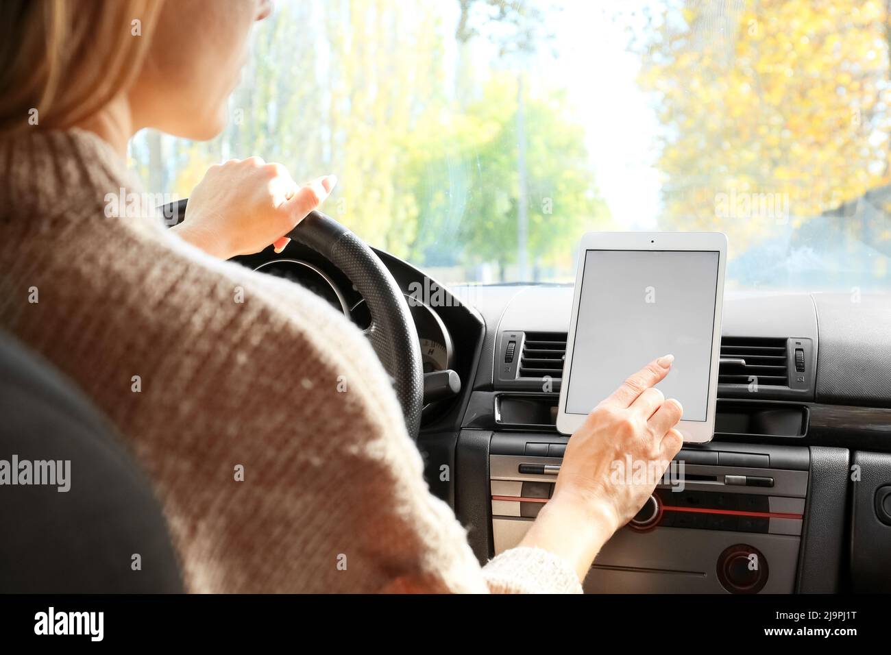 Female driver using tablet computer for navigation Stock Photo - Alamy