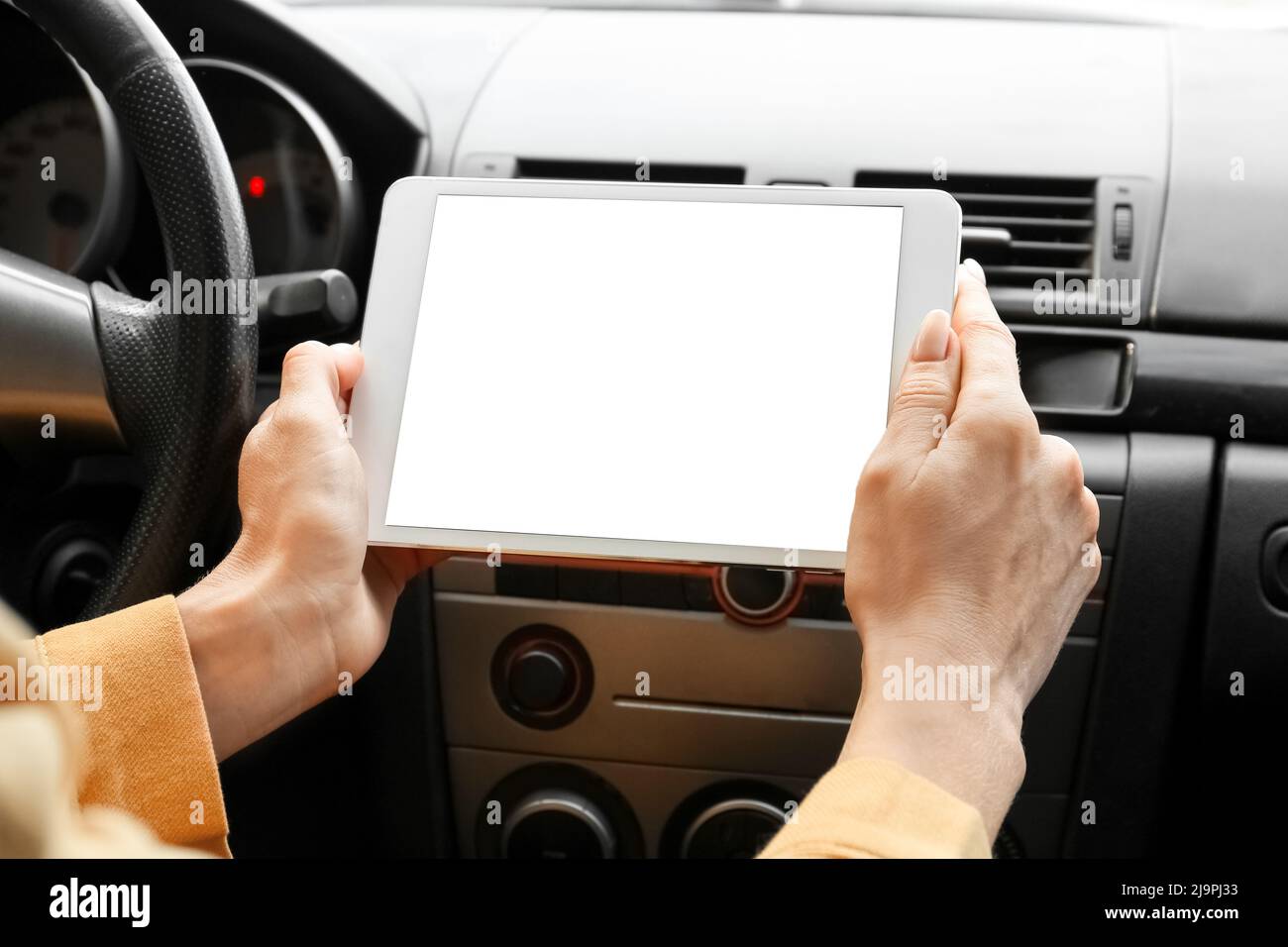 Female driver using tablet computer for navigation Stock Photo - Alamy