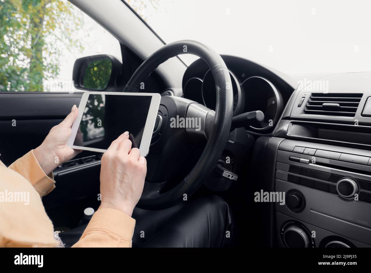 Female driver using tablet computer for navigation Stock Photo - Alamy