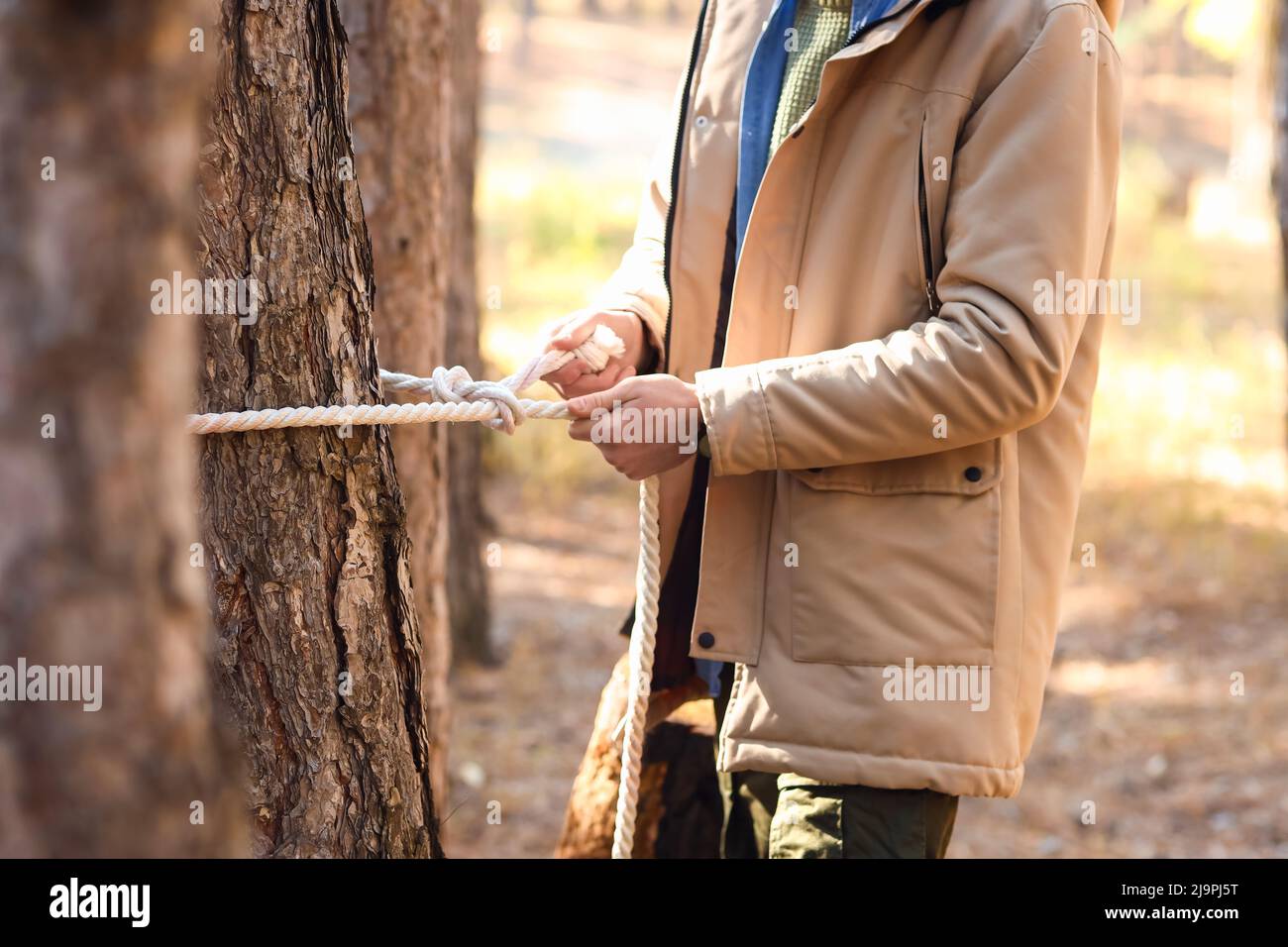 Tying rope tree camping hi-res stock photography and images - Alamy